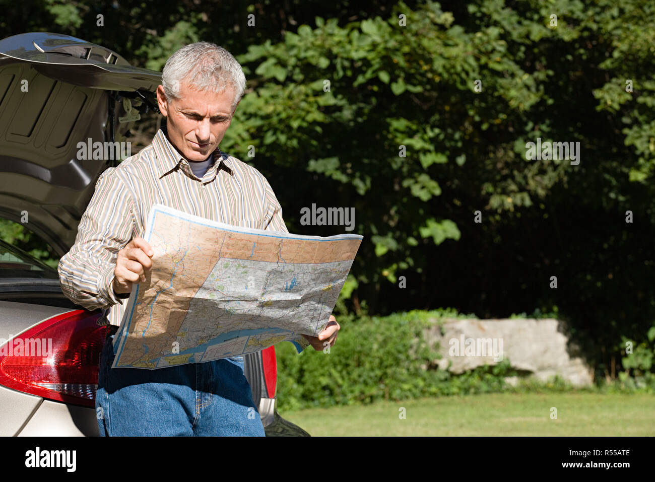 Man looking at map Stock Photo - Alamy