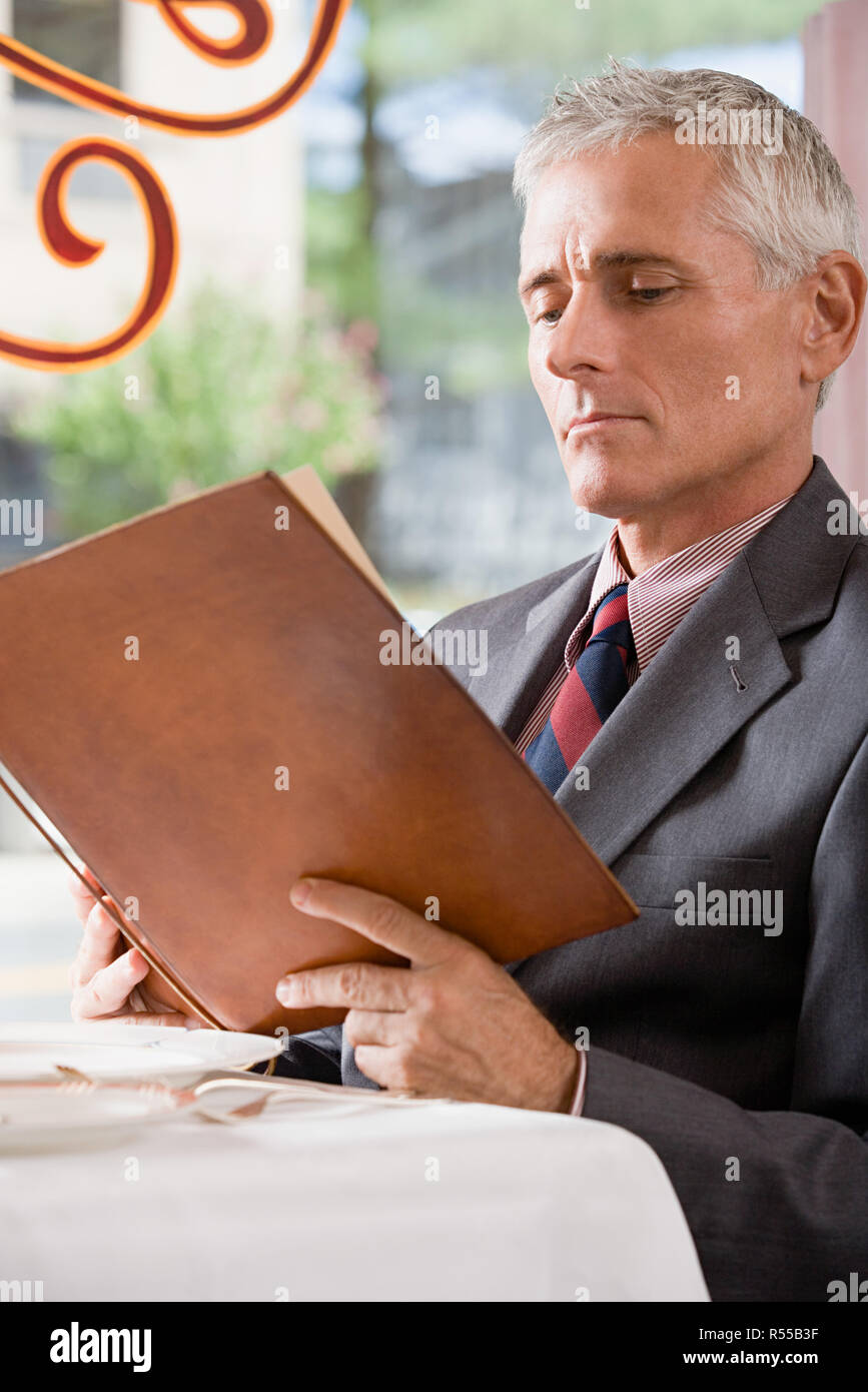 Man looking at a menu Stock Photo - Alamy