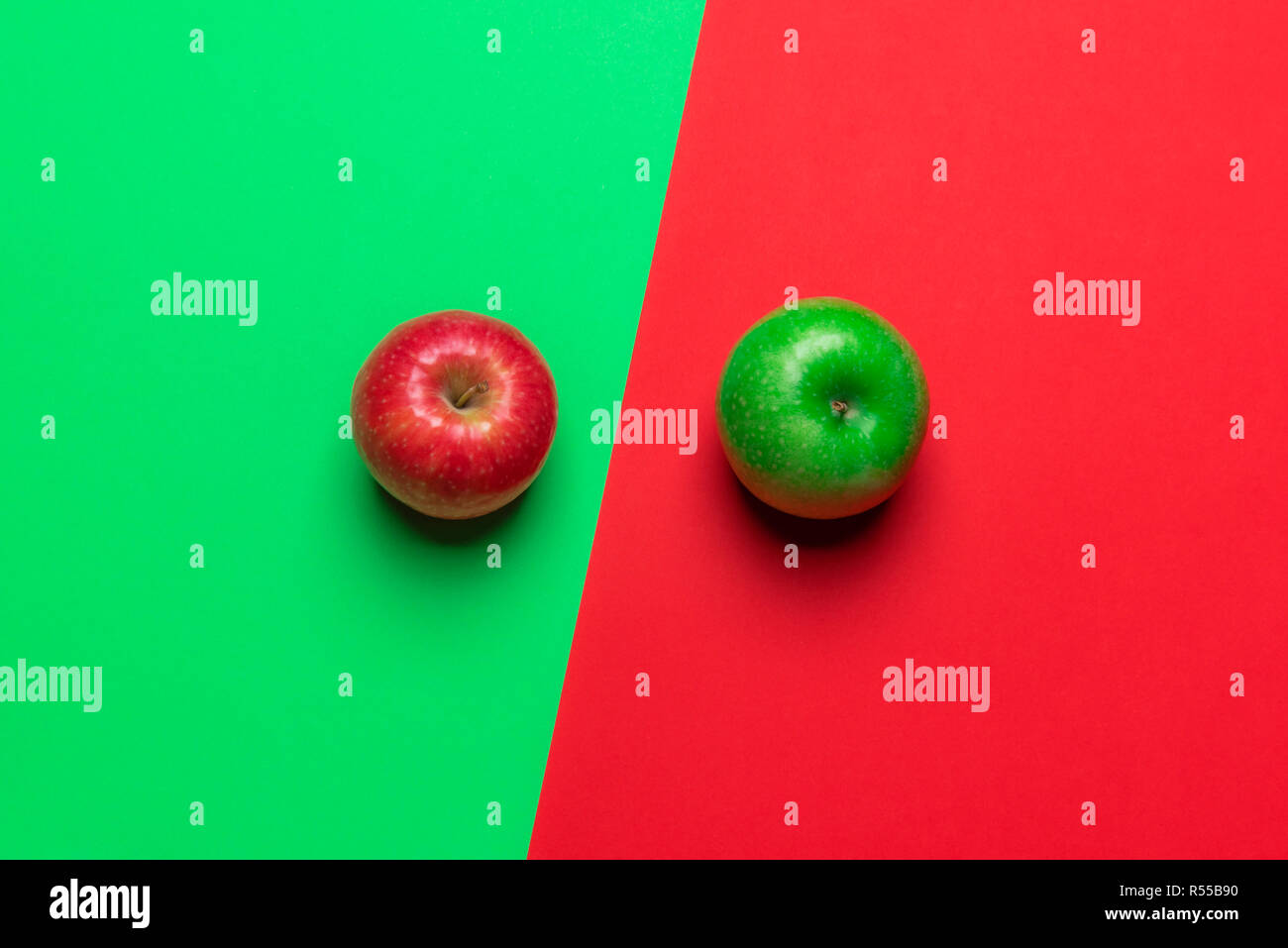 Top view of a bicolor table with a red and a green apple. Healthy ...