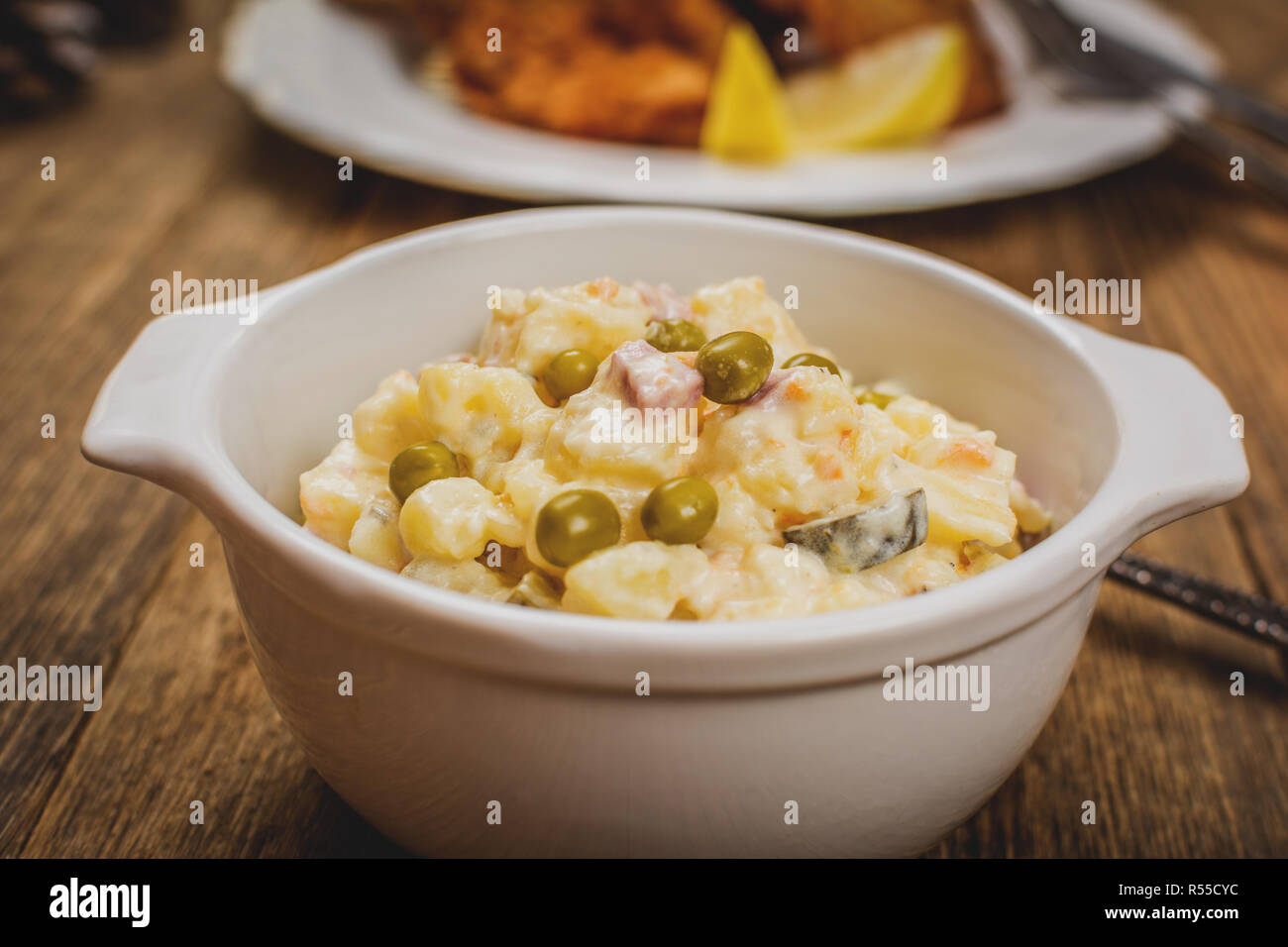 Traditional czech potato salad with mayonnaise and vegetables in white ...