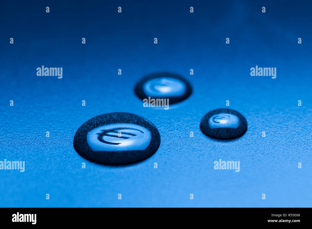 two euro drops on blue Stock Photo - Alamy