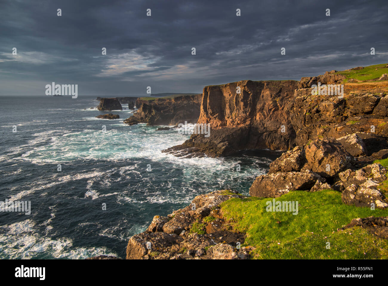 Sea cliffs and sea stacks at Eshaness / Esha Ness at sunset and ...