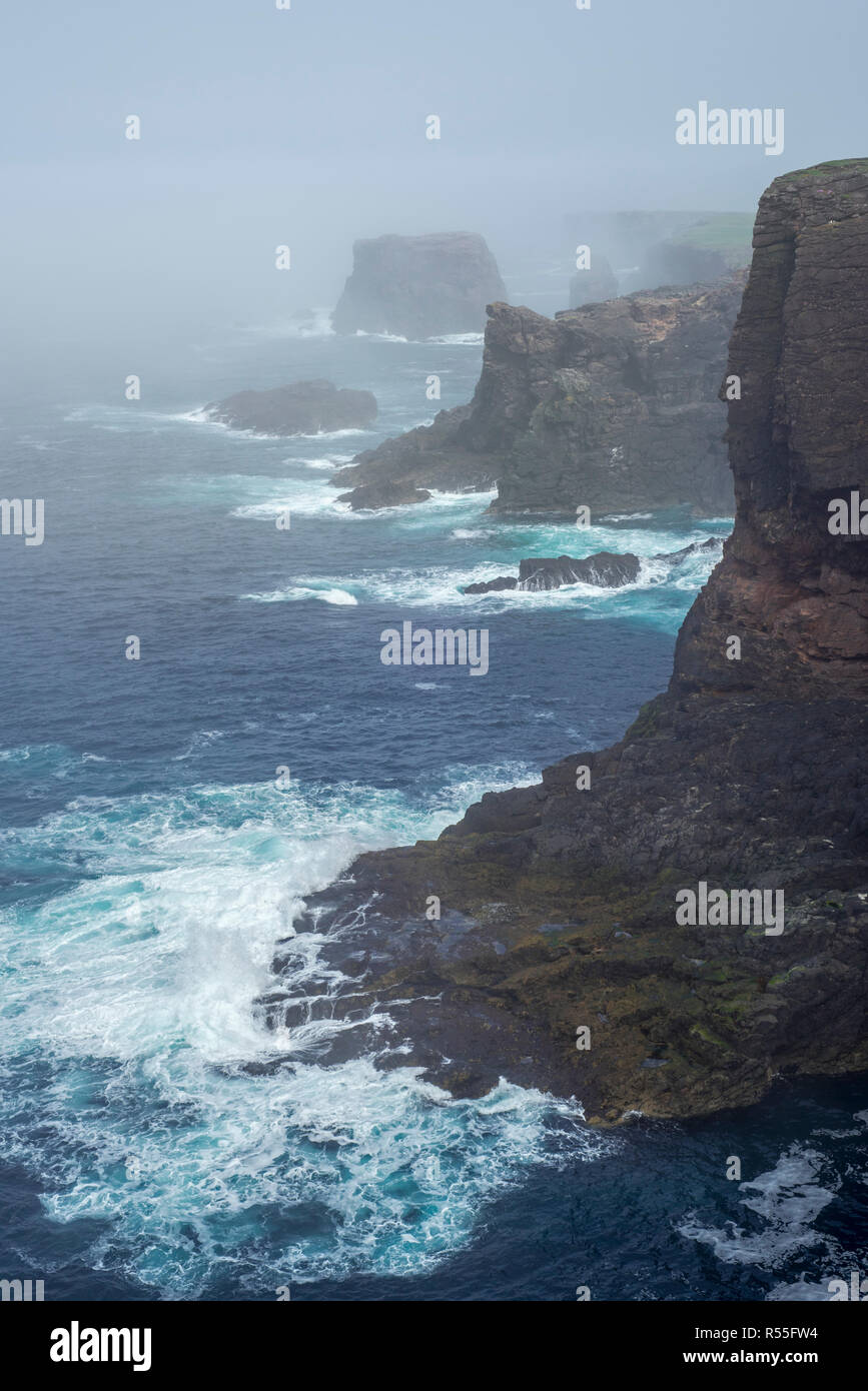 Sea stacks and sea cliffs in mist during stormy weather at Eshaness ...