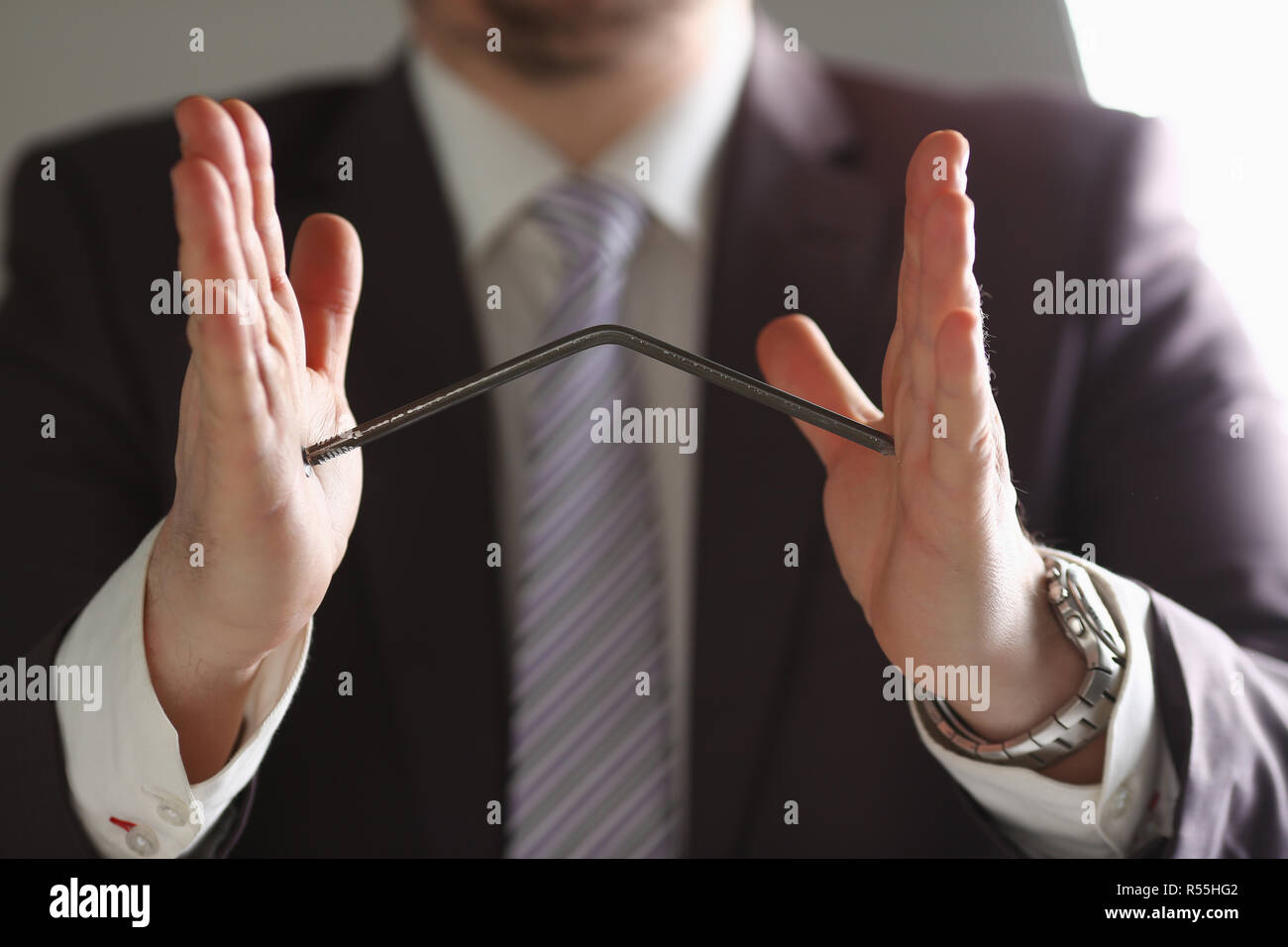 Male hands bend nail metal between palm Stock Photo - Alamy