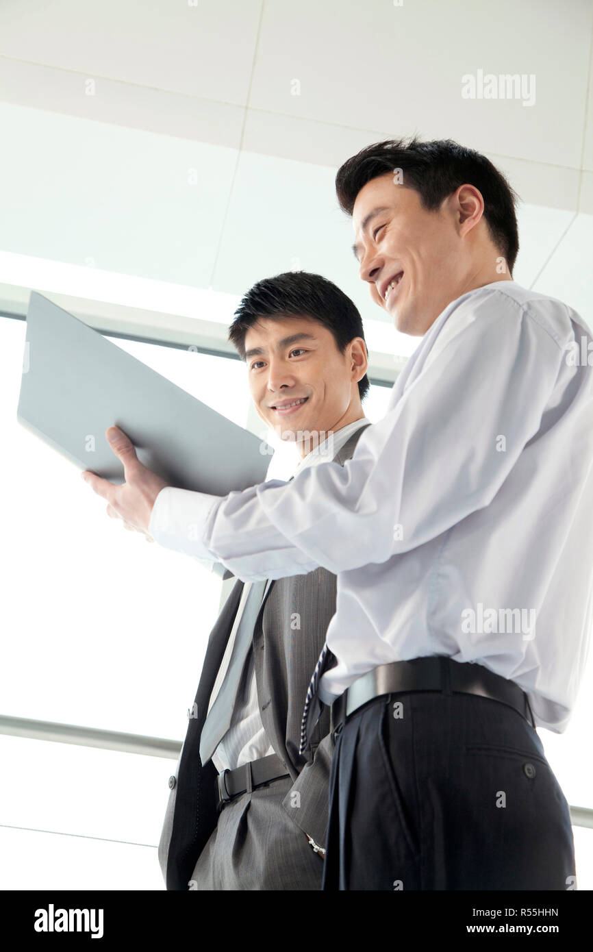 Two Businessmen working together Stock Photo - Alamy