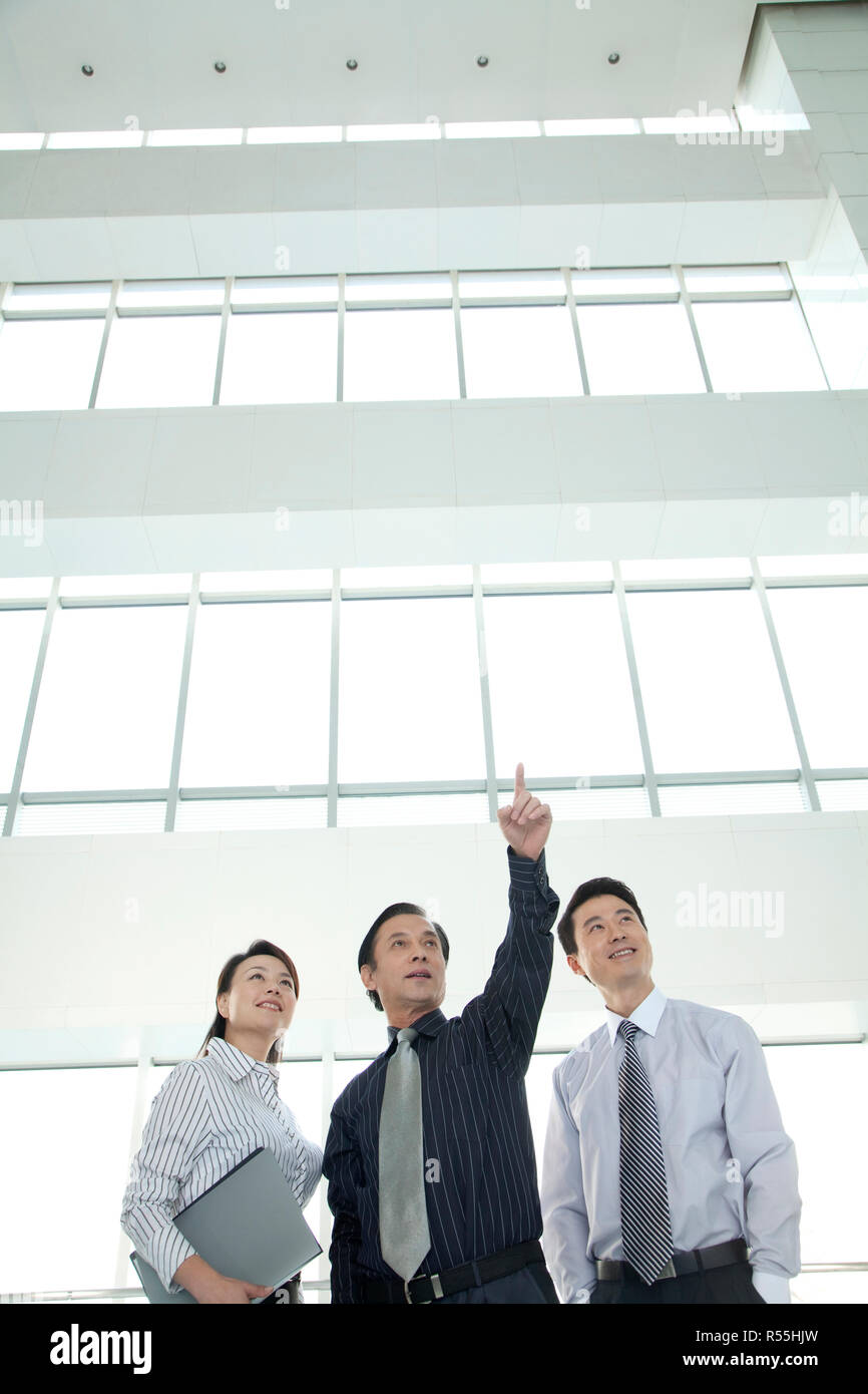 Three Businesspeople Looking Forward Stock Photo - Alamy
