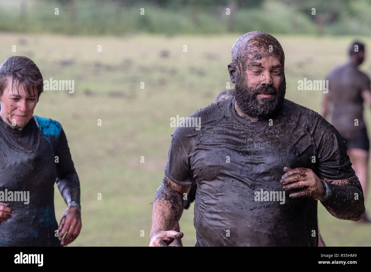Man and woman covered in mud at a mud run Stock Photo - Alamy