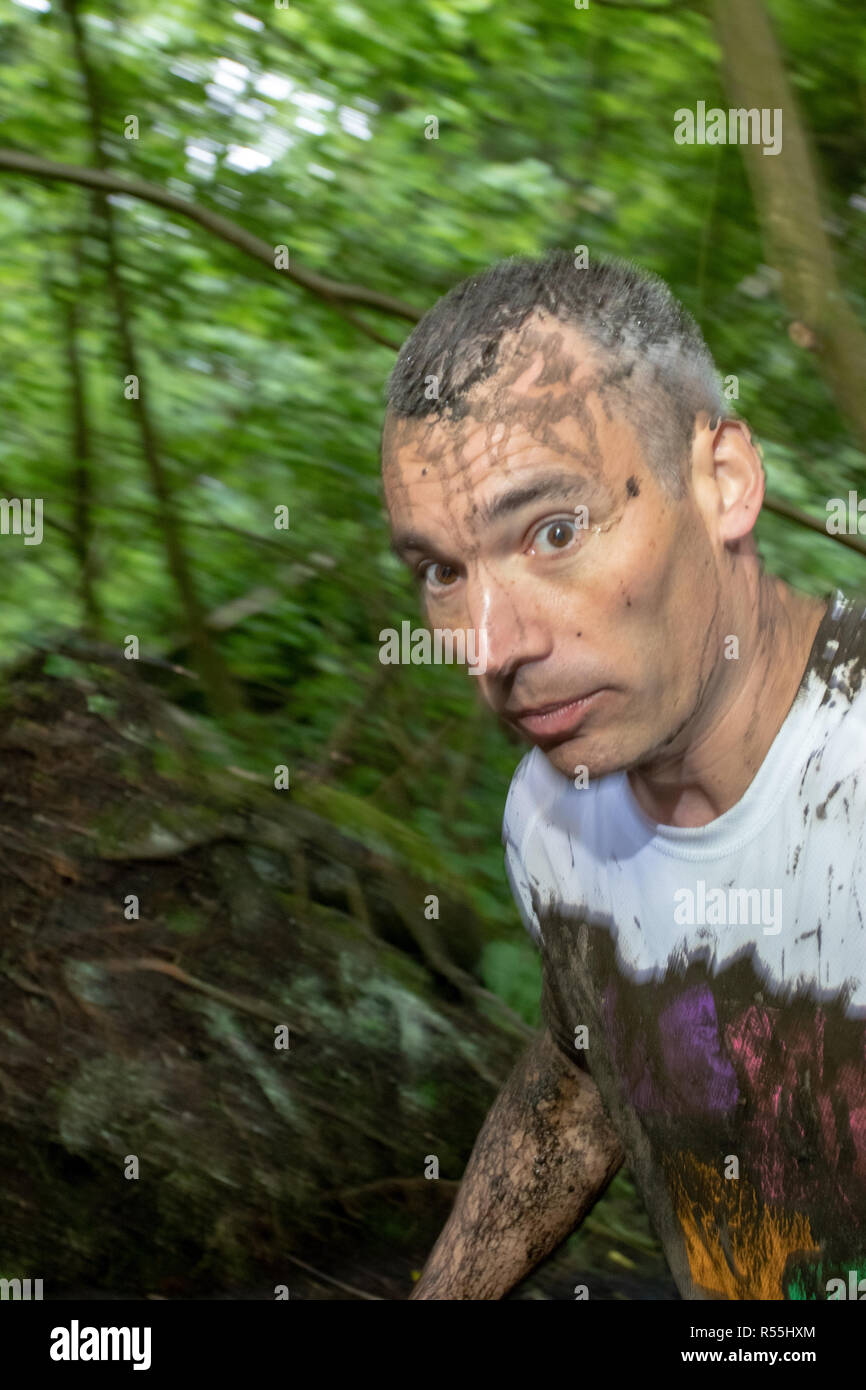 Man mud runner looks surprised Stock Photo - Alamy