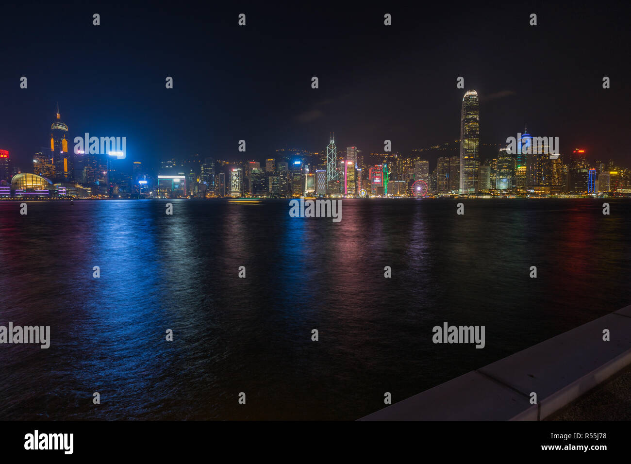 Hong Kong skyline and Victoria Harbour at night viewed from Kowloon public pier Stock Photo - Alamy