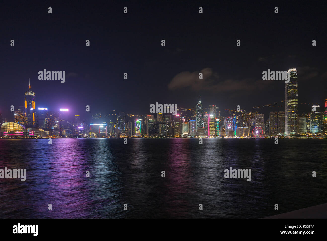 Hong Kong skyline and Victoria Harbour at night viewed from Kowloon public pier. Hong Kong, Tsim ...