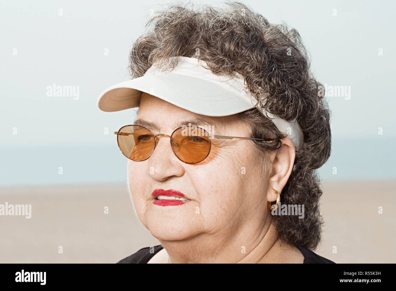 Woman wearing a sun visor Stock Photo - Alamy