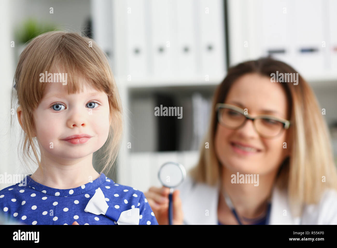 Little child with stethoscope at doctor reception Stock Photo - Alamy