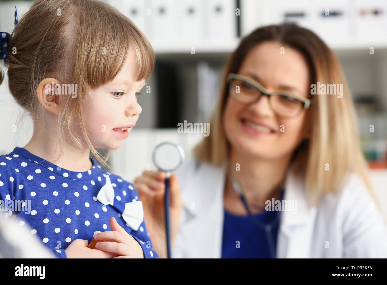 Little child with stethoscope at doctor reception Stock Photo - Alamy