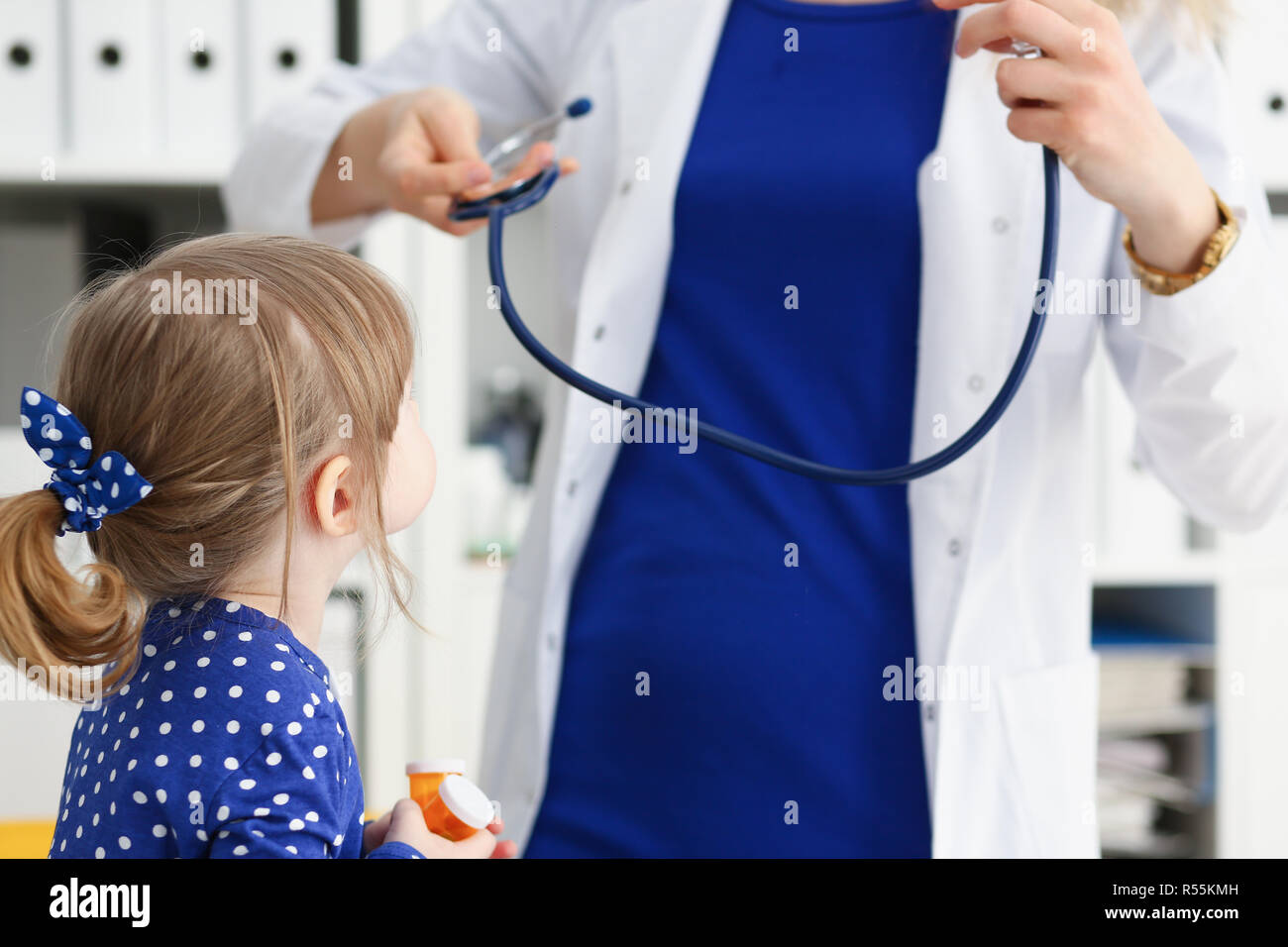Little child with stethoscope at doctor reception Stock Photo - Alamy