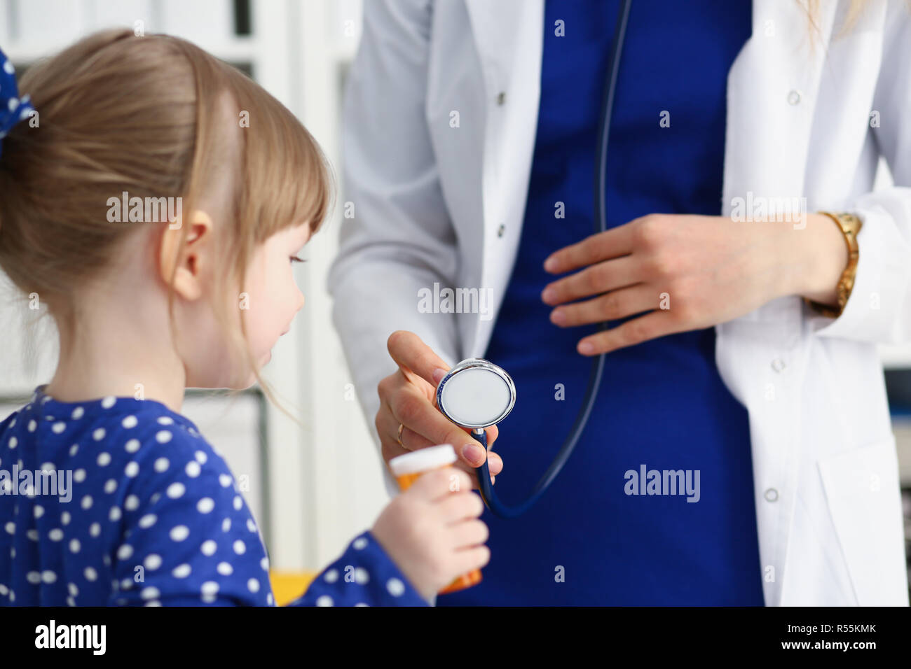 Little child with stethoscope at doctor reception Stock Photo - Alamy