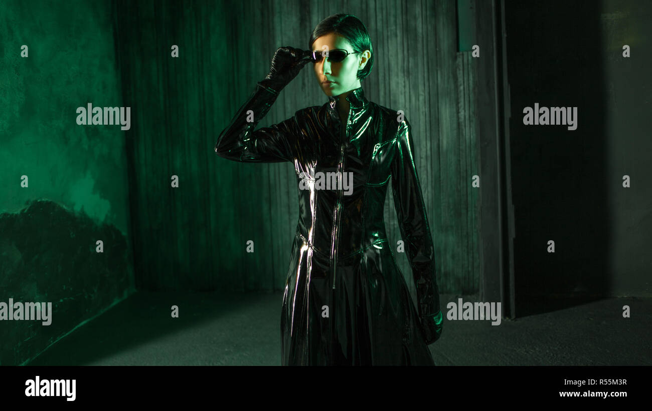 Girl hacker in the digital world. Young woman in matrix style suit ...
