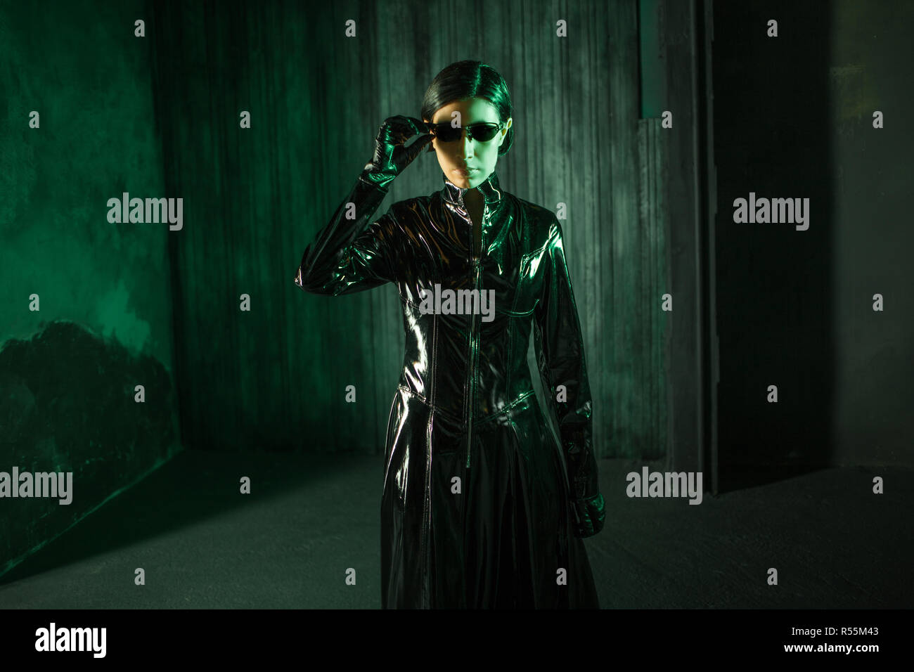 Girl hacker in the digital world. Young woman in matrix style suit ...