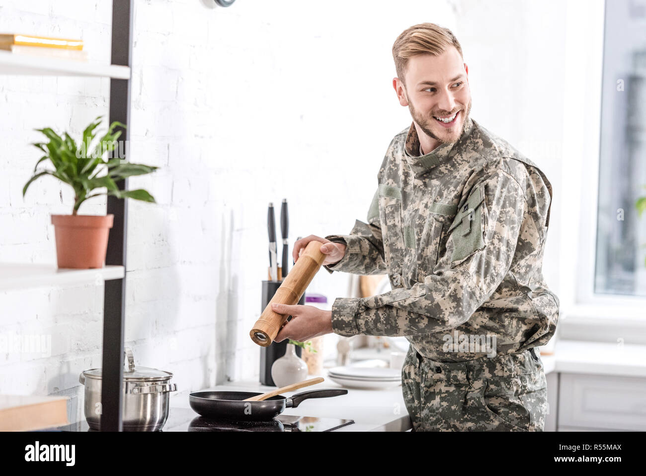 army soldier using pepper pot while cooking in kitchen Stock Photo - Alamy