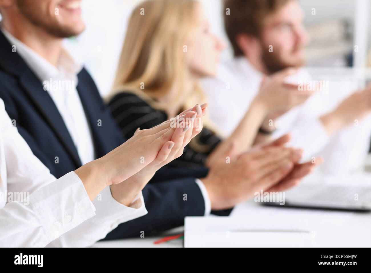 Group of people clap their arm in row during Stock Photo - Alamy
