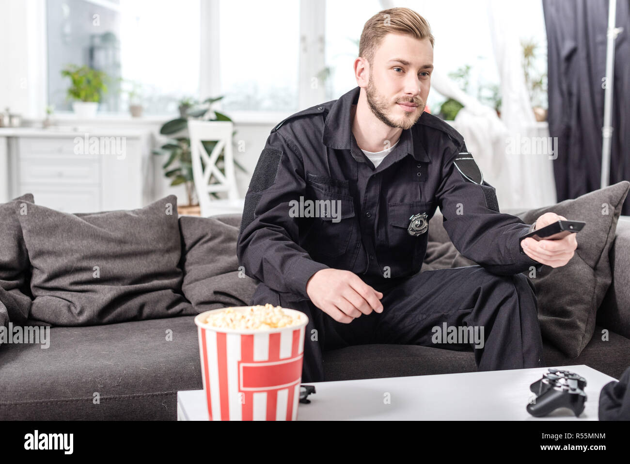 Male police officer sitting in hi-res stock photography and images - Alamy