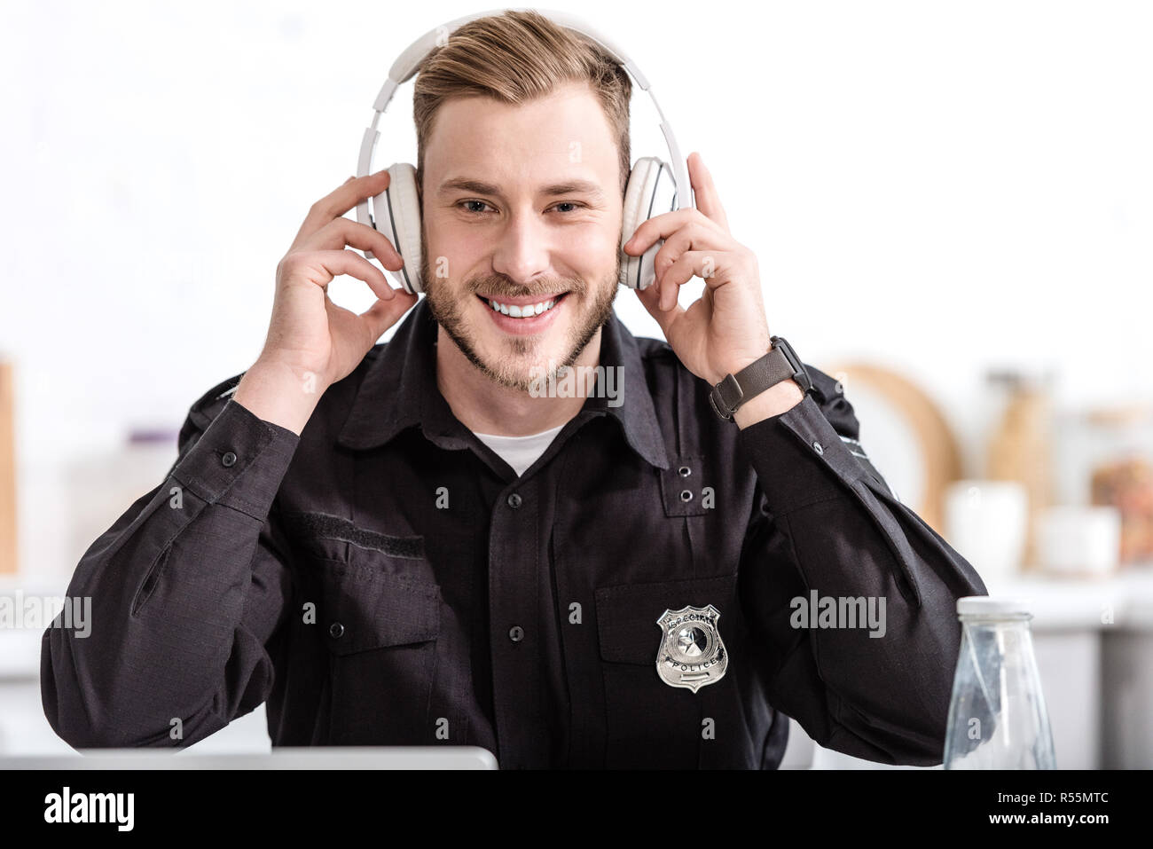 police officer smiling and listening to music with headphones at ...