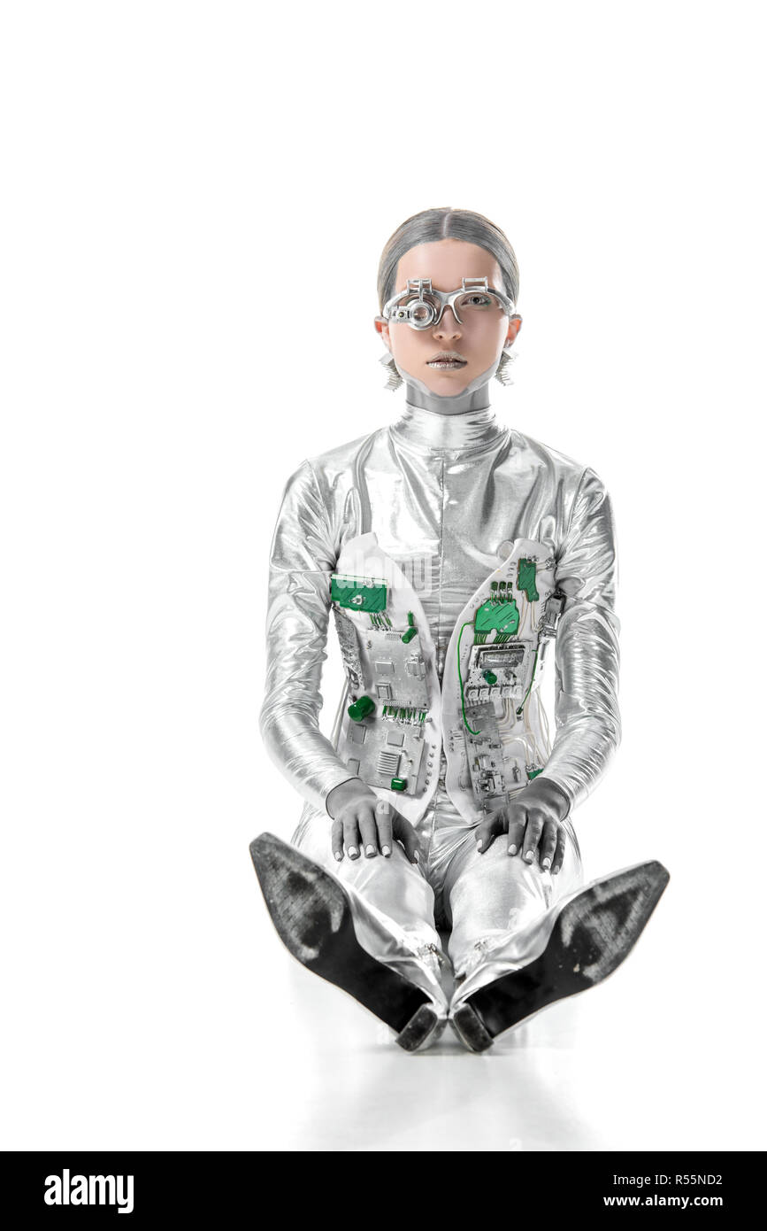 silver robot sitting and looking at camera isolated on white, future ...