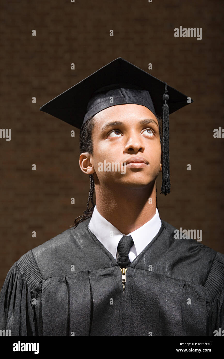 Male graduate looking up Stock Photo - Alamy