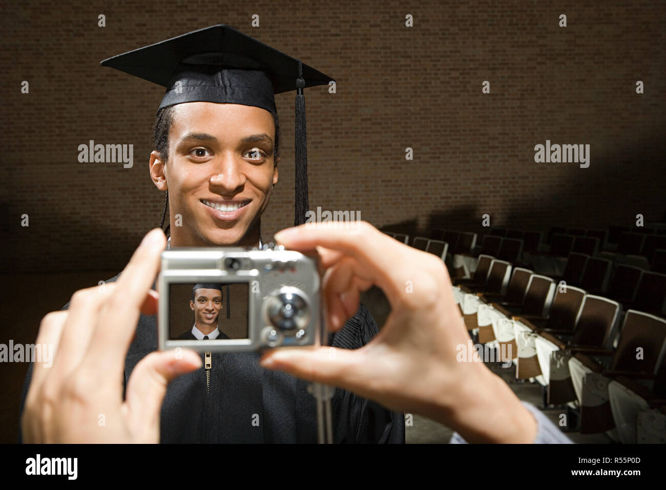 Male graduate being photographed Stock Photo - Alamy