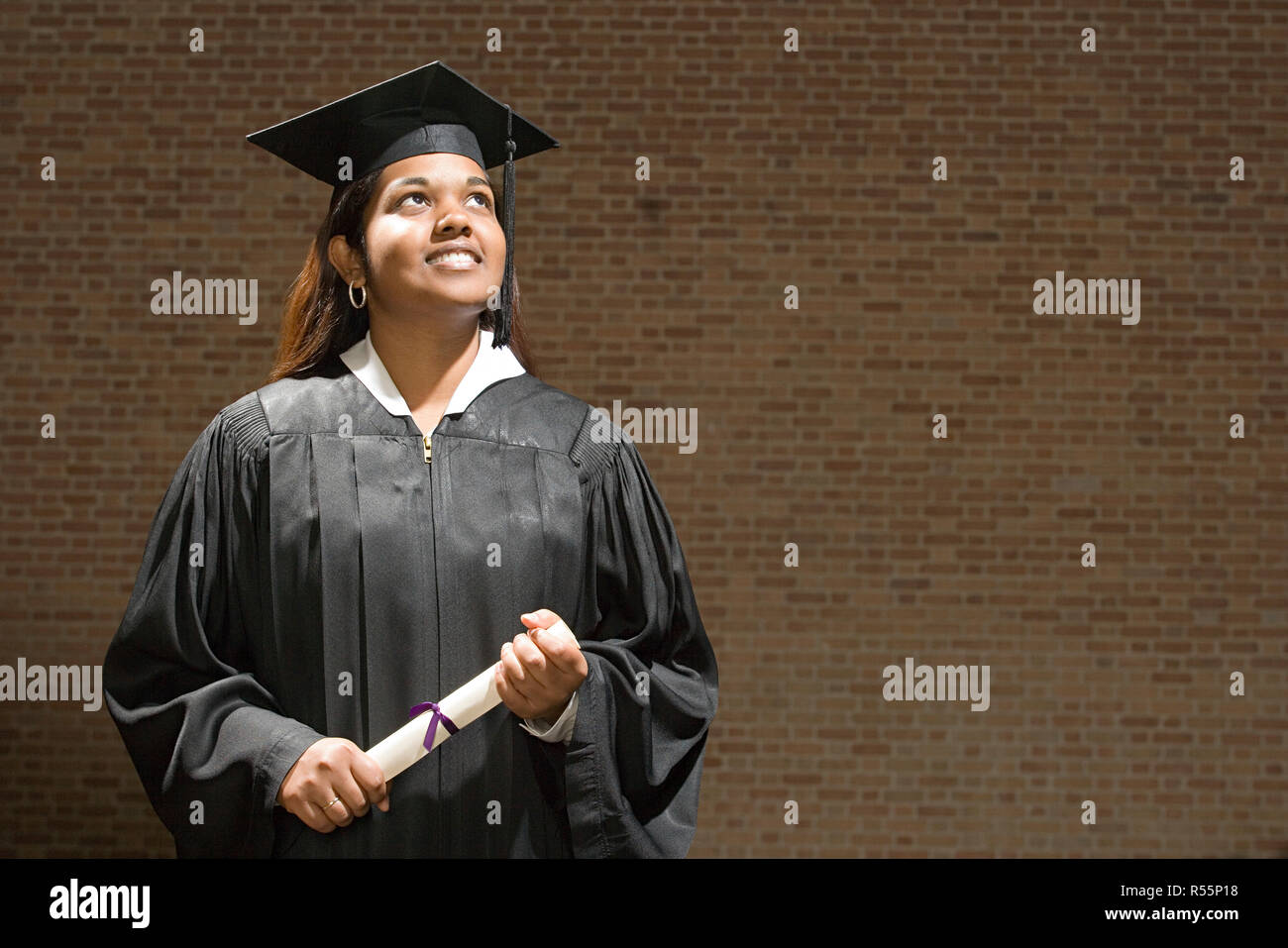 Female graduate holding a diploma Stock Photo - Alamy