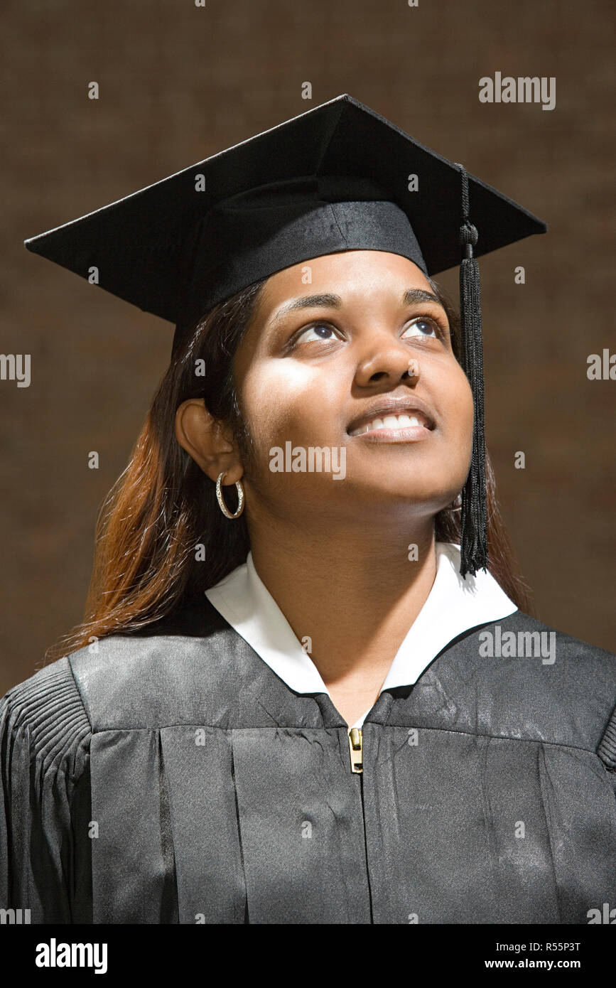 Female graduate looking up Stock Photo - Alamy