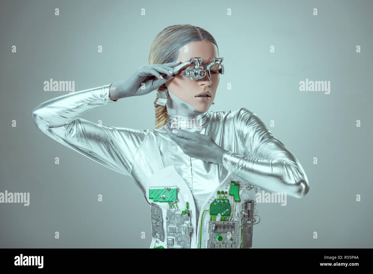 young woman robot posing isolated on grey, future technology concept ...