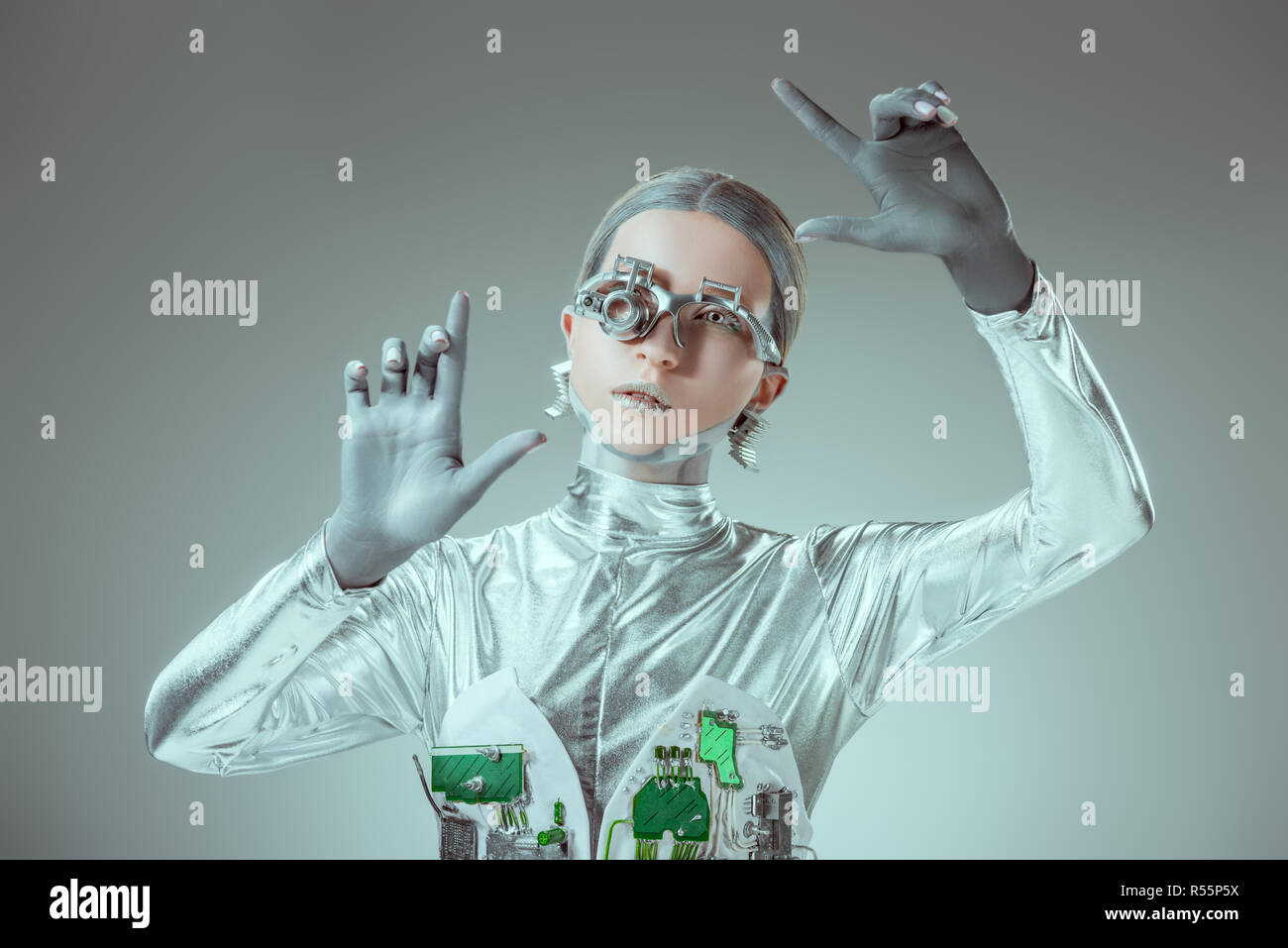 futuristic silver robot gesturing with hands isolated on grey, future ...