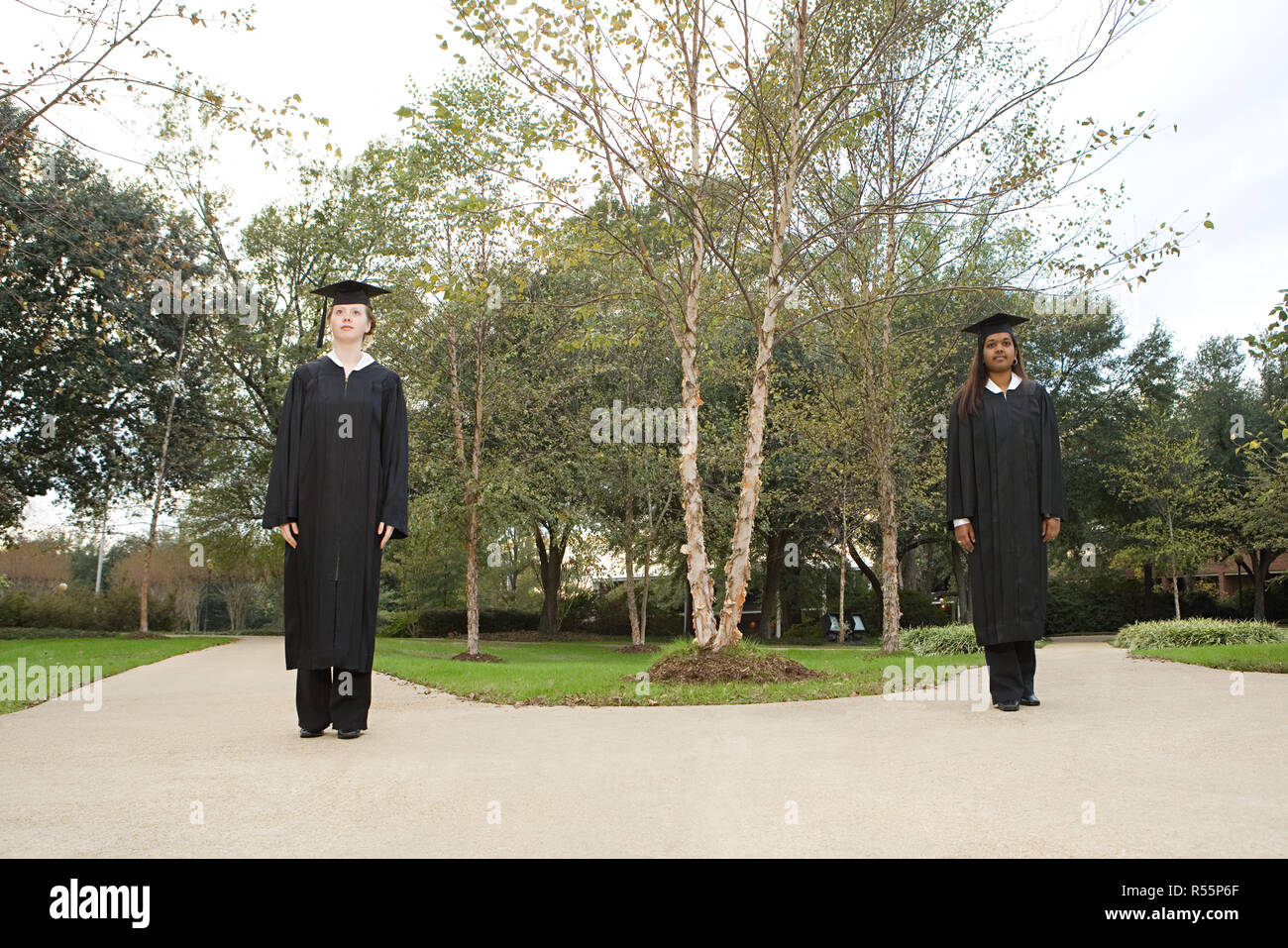 Two female graduates choosing a path Stock Photo - Alamy