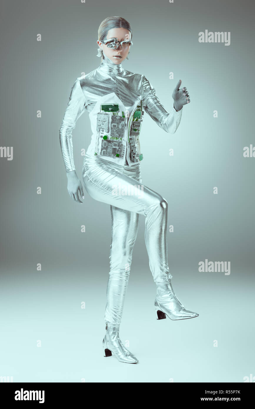 full length view of silver cyborg walking on grey, future technology ...
