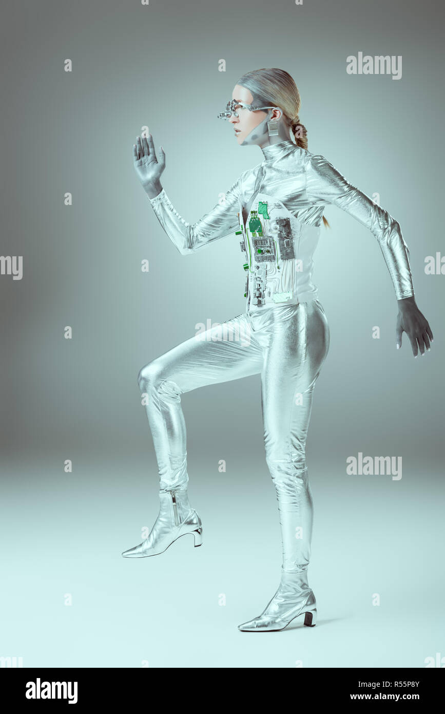 side view of futuristic cyborg walking on grey, future technology ...