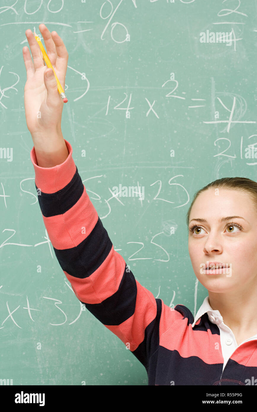 Female student with her hand raised Stock Photo - Alamy