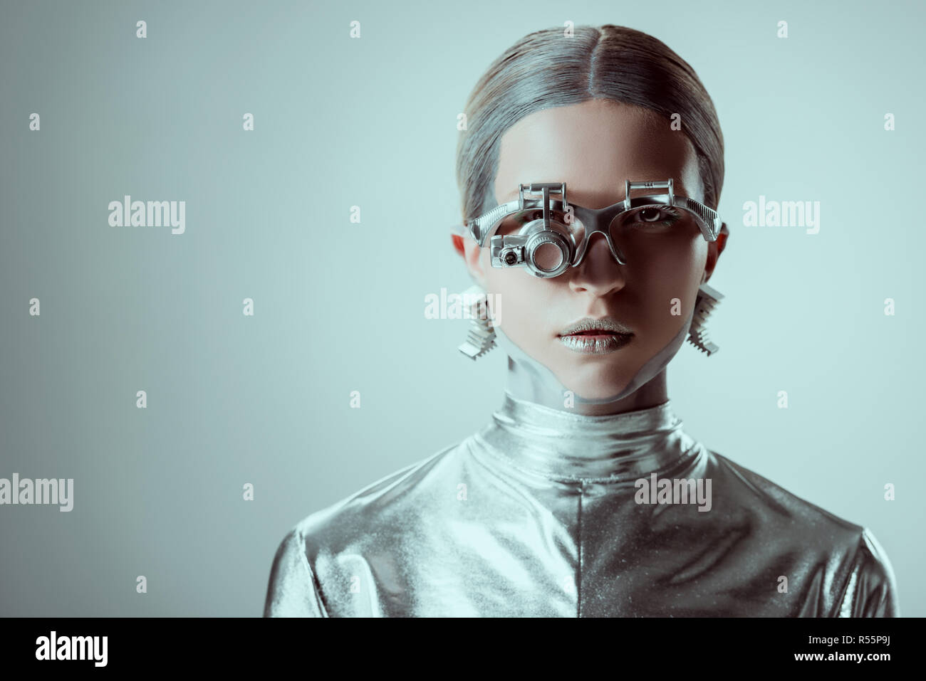 futuristic silver robot looking at camera isolated on grey, future ...