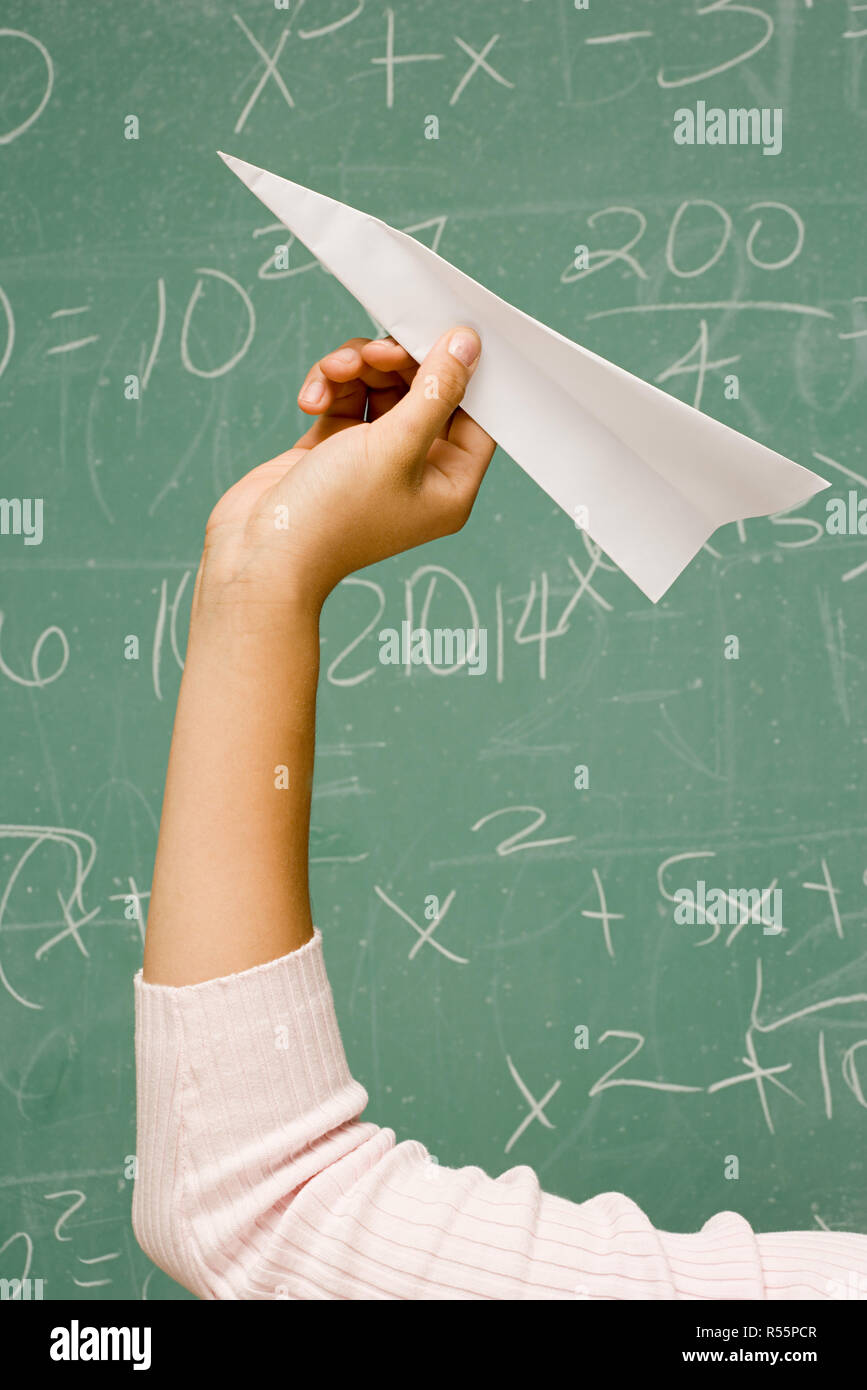 Student about to throw a paper aeroplane Stock Photo - Alamy