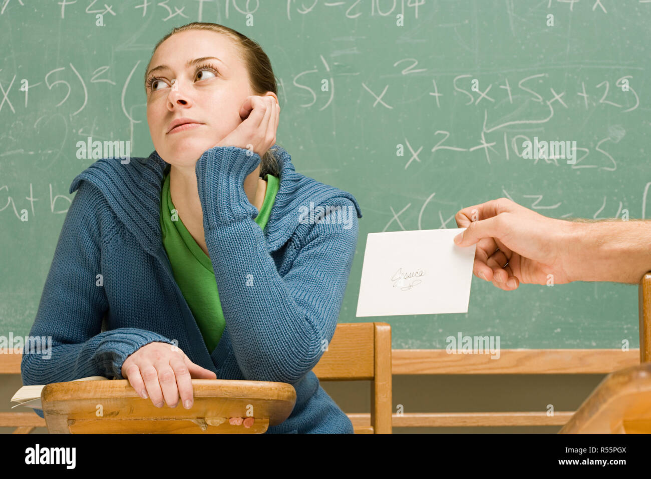 Boy passing girl a letter in class Stock Photo - Alamy