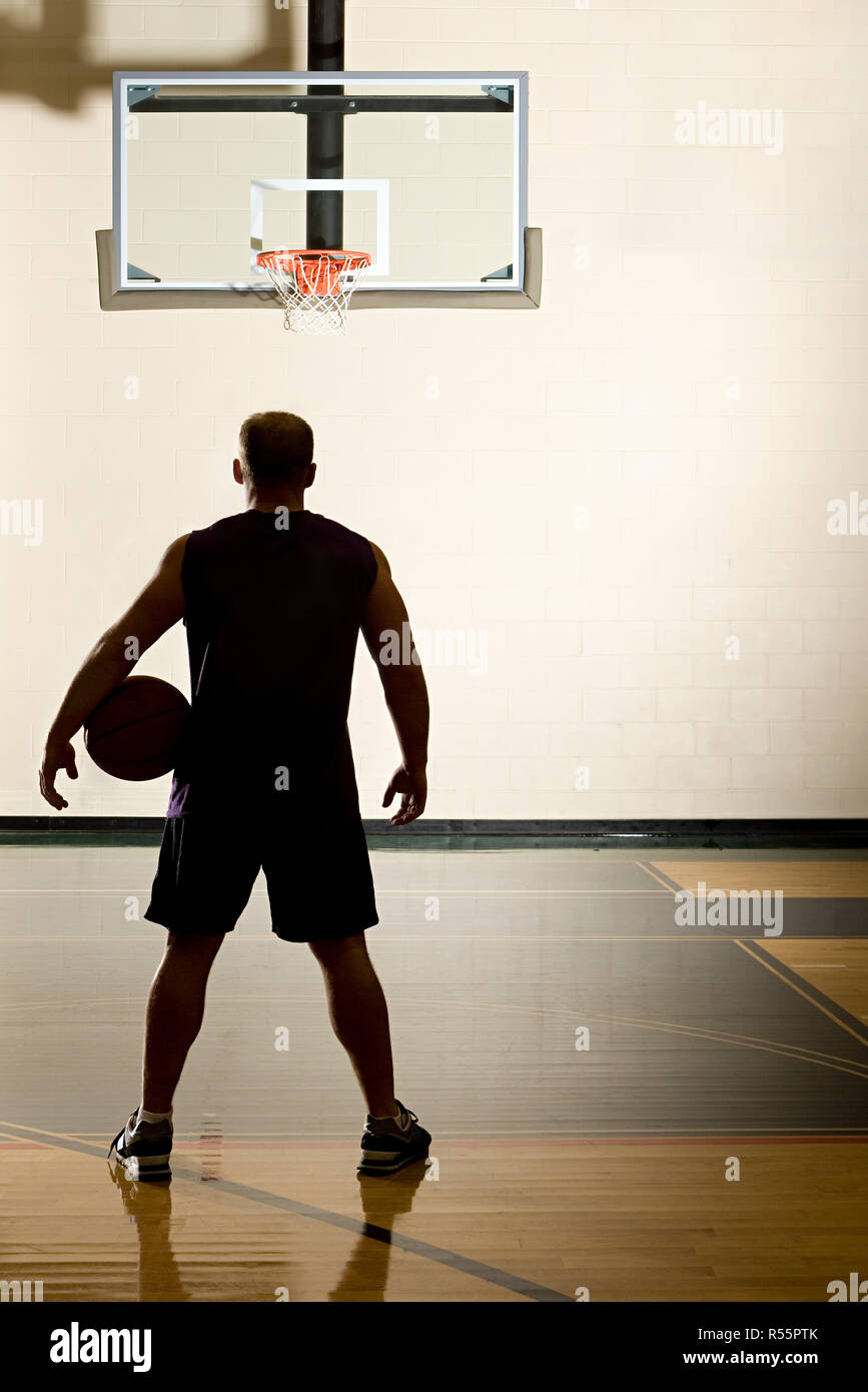 Basketball player alone in basketball court Stock Photo - Alamy