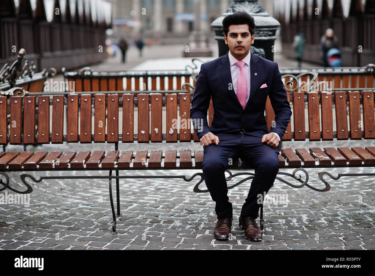 Elegant indian macho man model on suit and pink tie posed on winter day ...