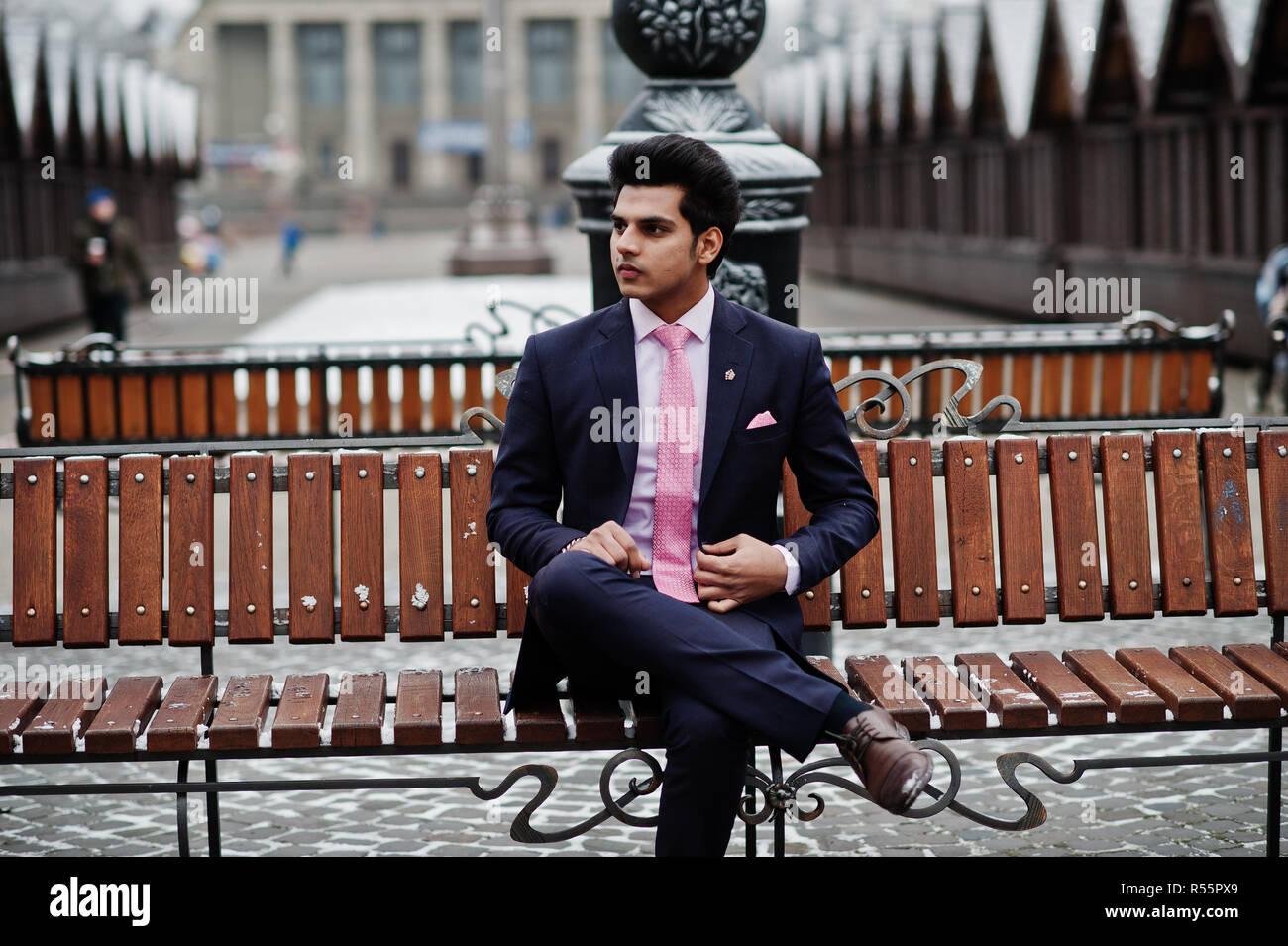 Elegant indian macho man model on suit and pink tie posed on winter day ...