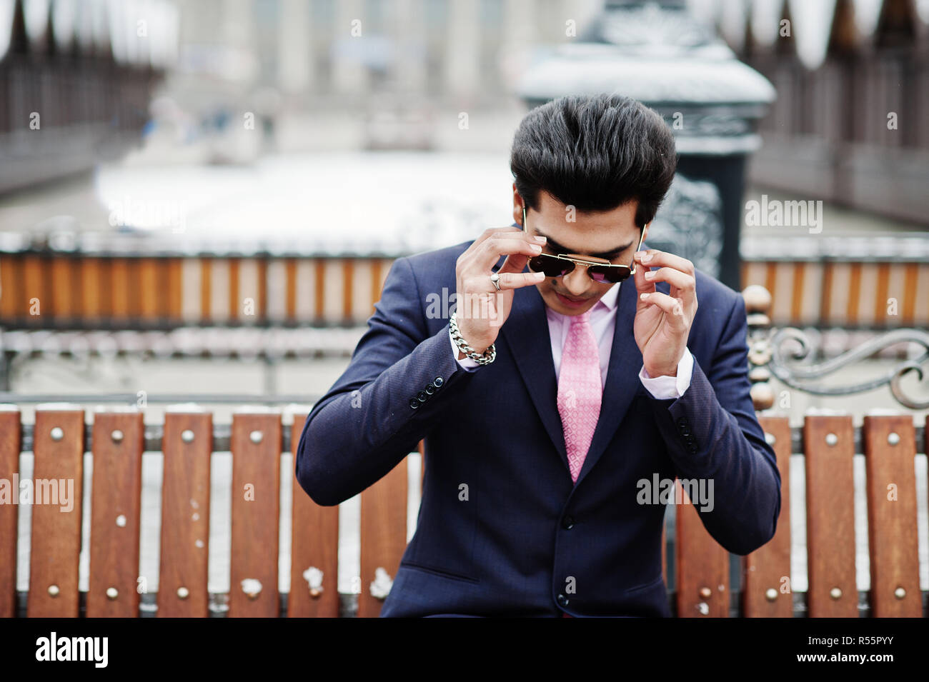 Elegant indian macho man model on suit and pink tie, sunglasses posed ...