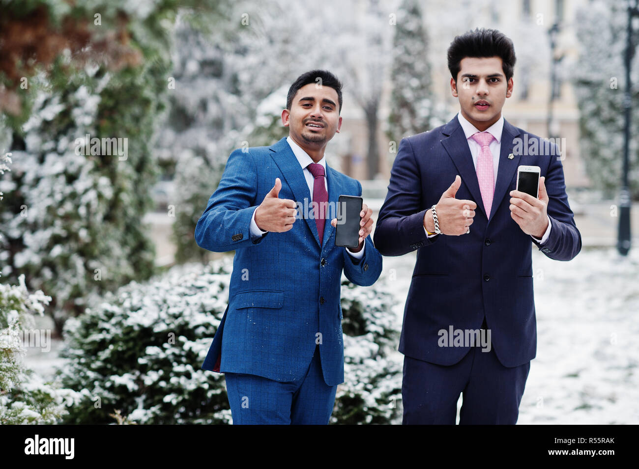 Two elegant indian fashionable mans model on suit posed at winter day ...