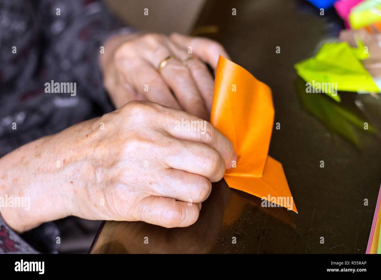 Hands of senior lady folding Origami paper Stock Photo - Alamy