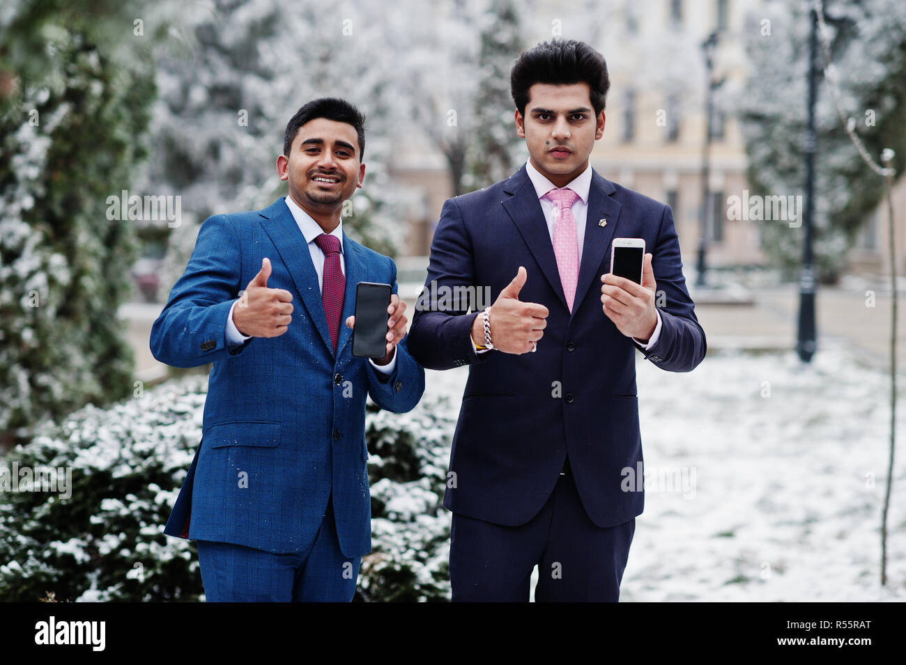 Two elegant indian fashionable mans model on suit posed at winter day ...