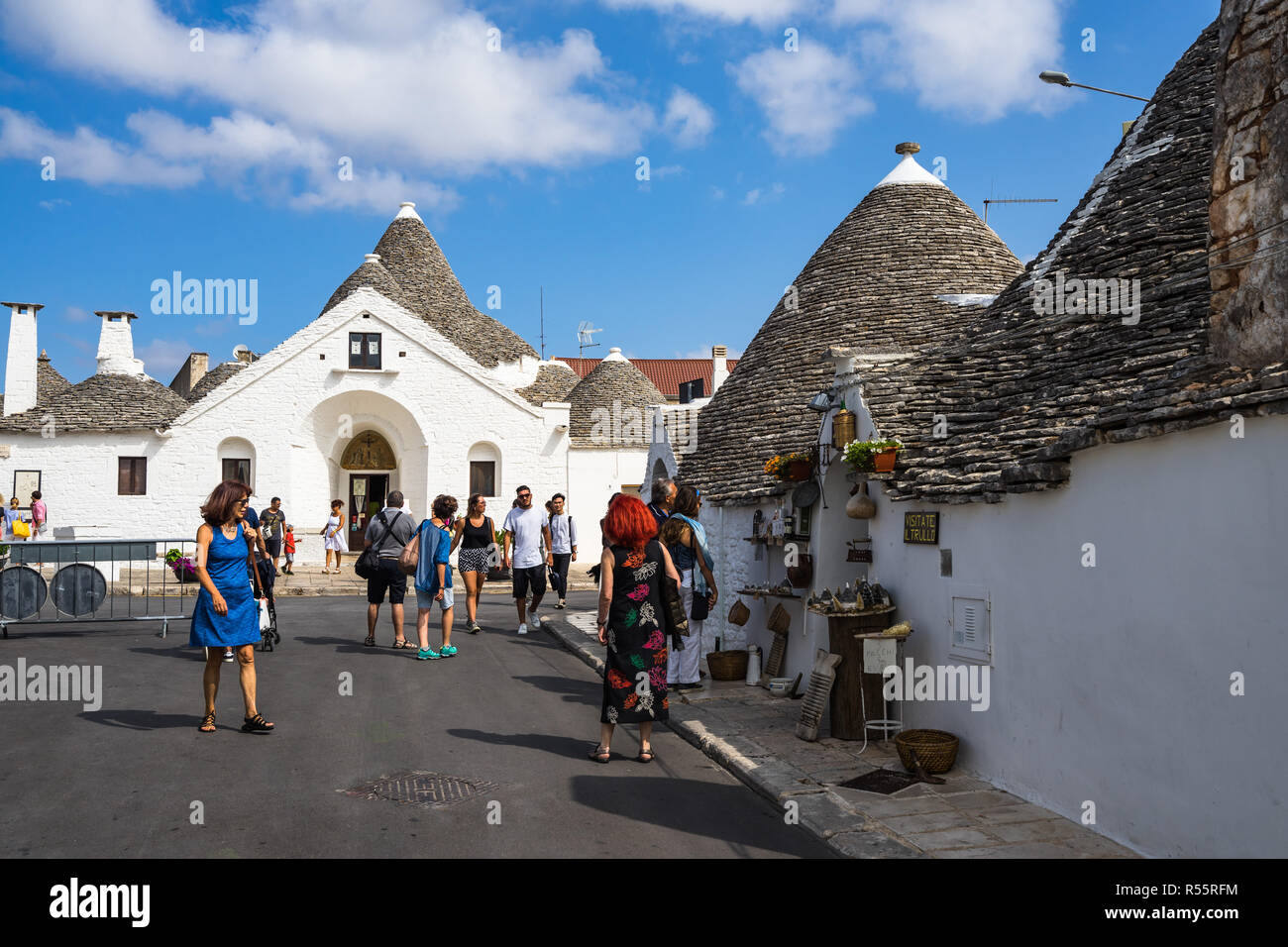 Tourist at the entrance of "Trullo Sovrano". Inside there is a small ...