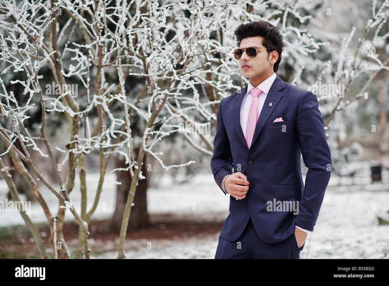Elegant indian macho man model on suit and pink tie, sunglasses posed ...