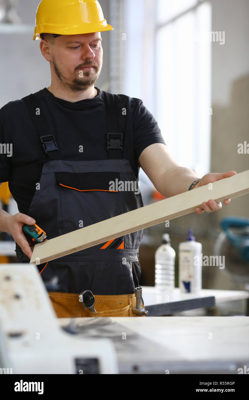 Portrait of a smiling carpenter holding wood planks Stock Photo - Alamy