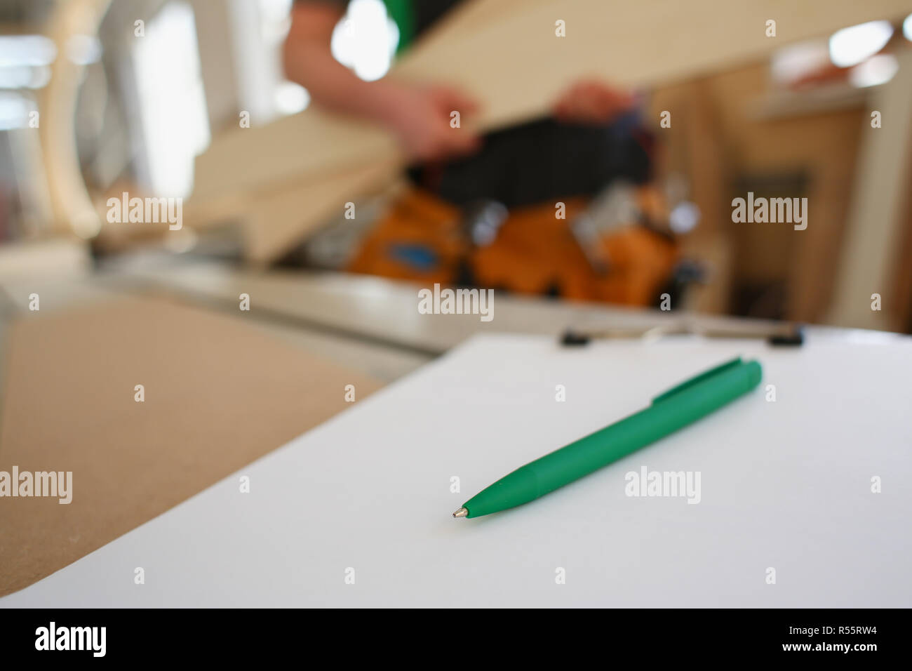 Drafting green pen lying on desk on clipboard Stock Photo - Alamy